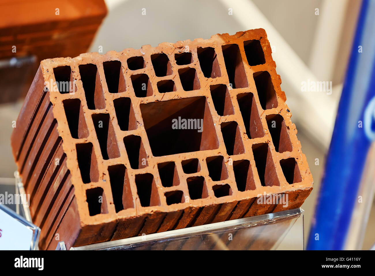 Detail of orange hollow clay block on a stand at construction fair ...