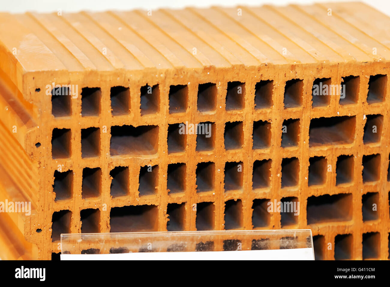 Detail of orange hollow clay block on a stand at construction fair ...