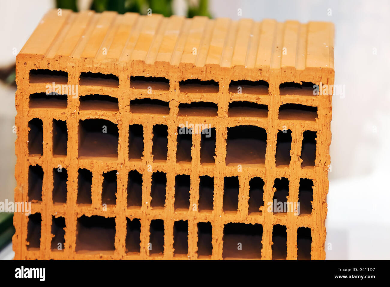 Detail of orange hollow clay block on a stand at construction fair ...