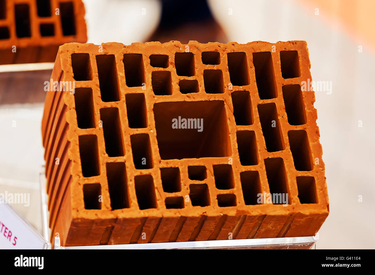 Detail of orange hollow clay block on a stand at construction fair ...