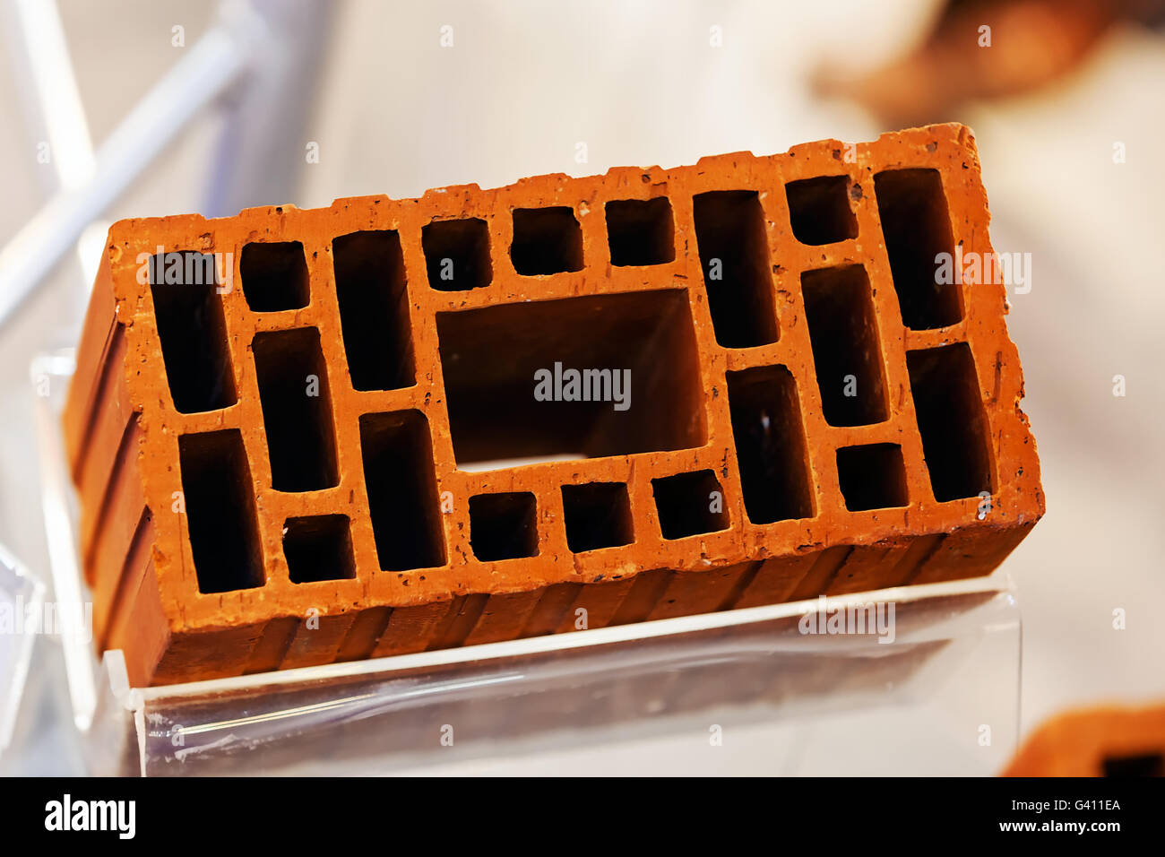 Detail of orange hollow clay block on a stand at construction fair ...