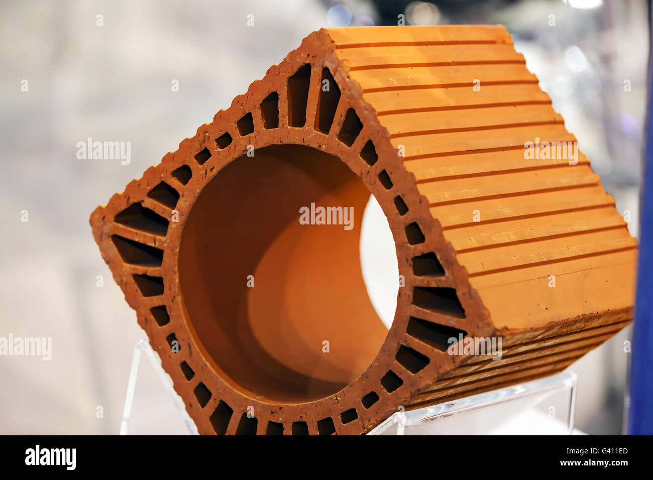 Detail of orange hollow clay block on a stand at construction fair ...