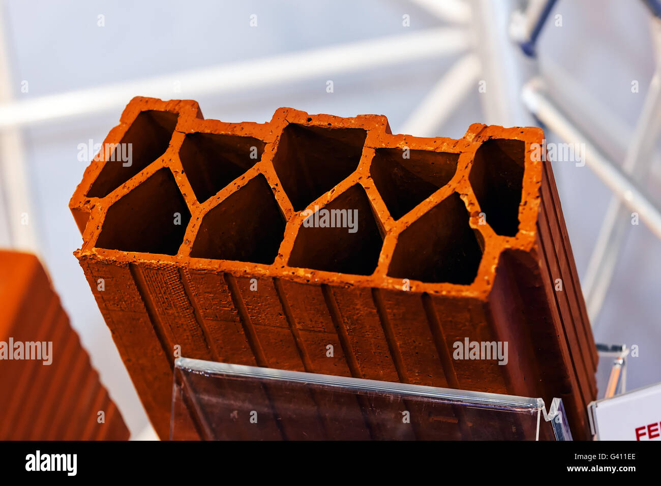 Detail of orange hollow clay block on a stand at construction fair ...