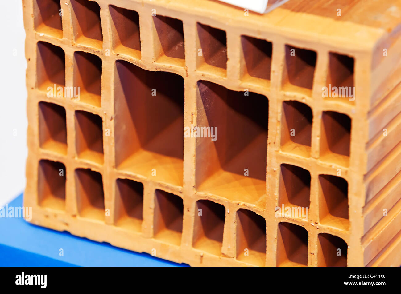 Detail of orange hollow clay block on a stand at construction fair ...