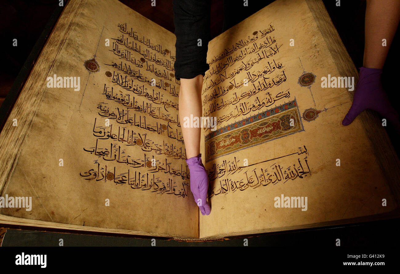 Conservation Intern Elaine Sheldon holds the pages of the Koran of ...