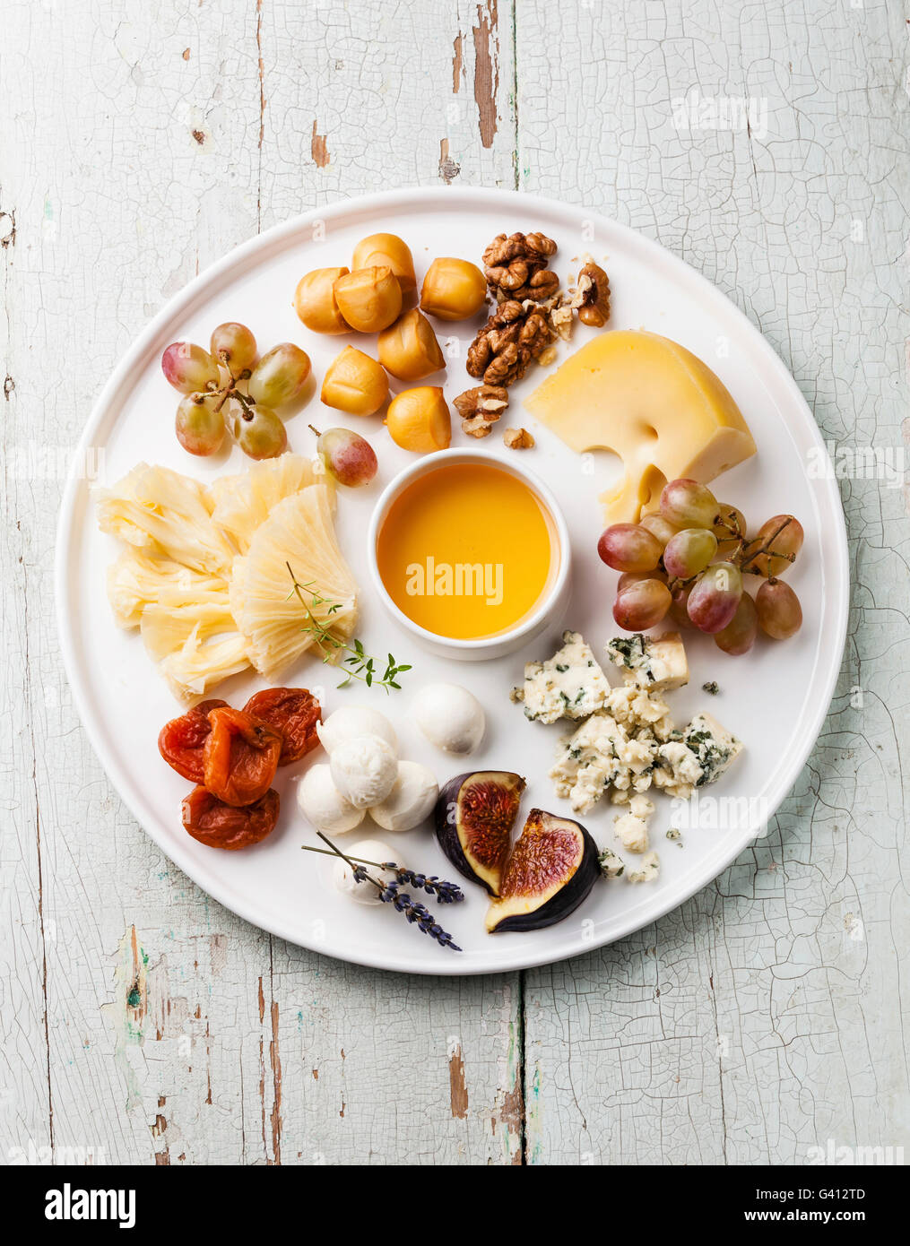 Cheese plate Snacks assortment with honey on white plate Stock Photo ...