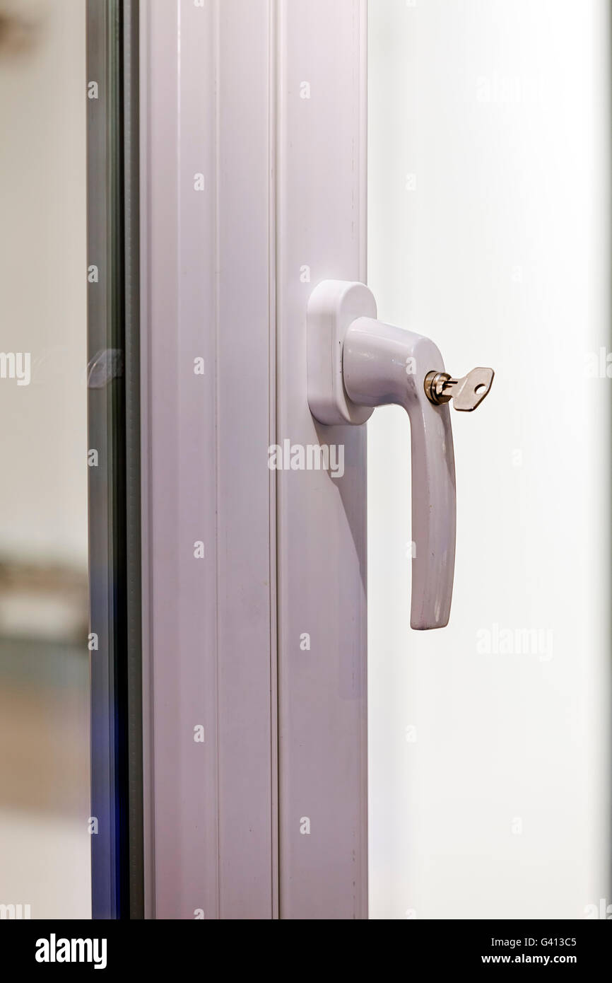 Metal door handle mechanism on pvc window Stock Photo - Alamy