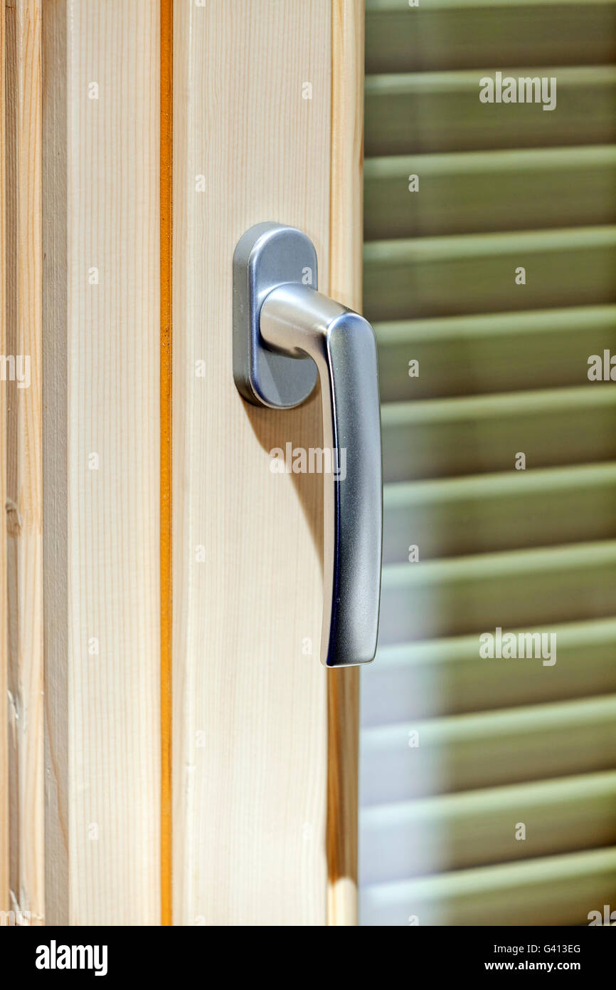 Metal door handle mechanism on pvc window, wooden design Stock Photo ...