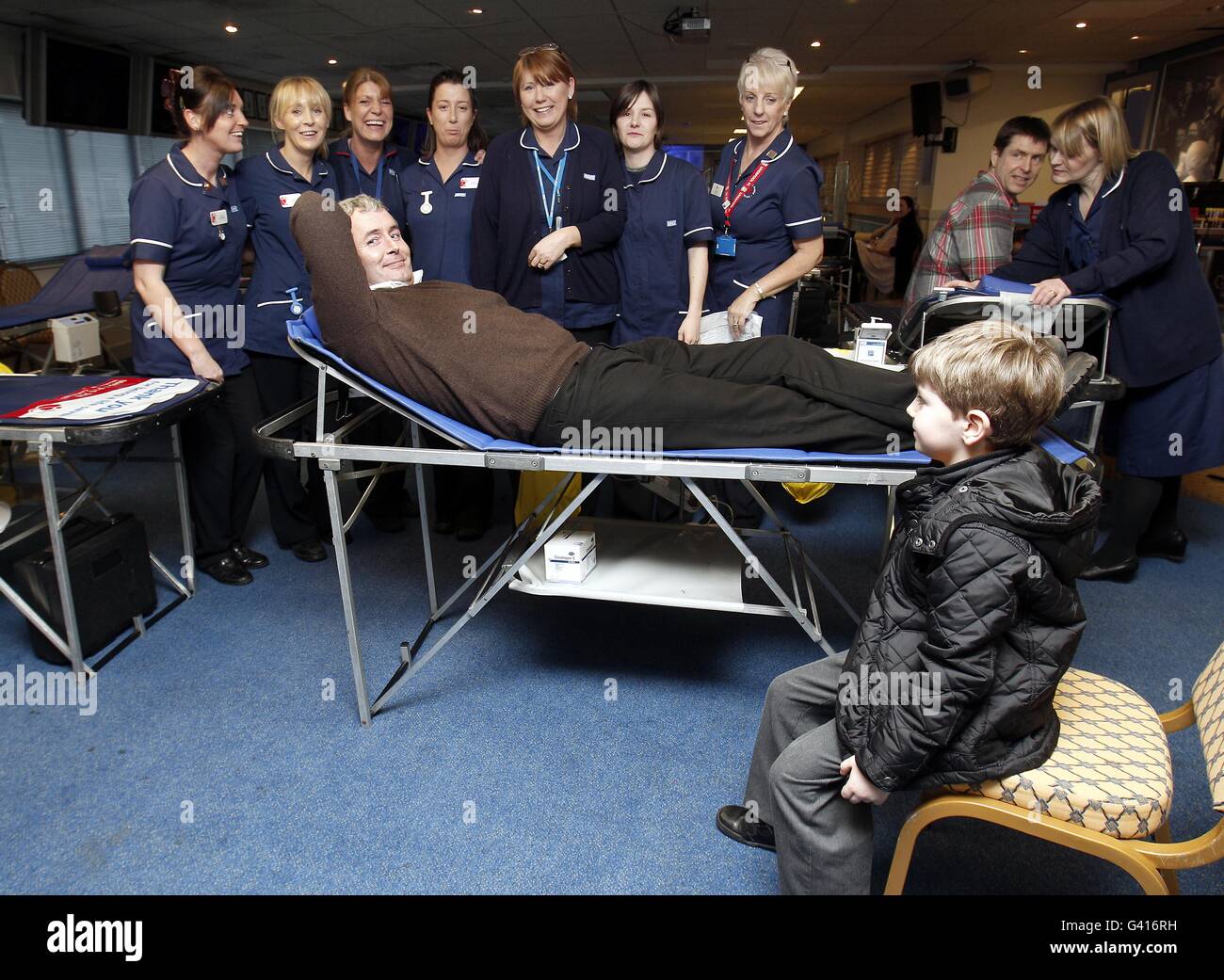 Tony Doyle and his son Shay (6) gives blood at goodison park home of ...