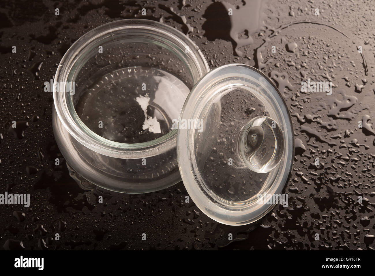 top view of an empty glass jar on black wet background Stock Photo - Alamy