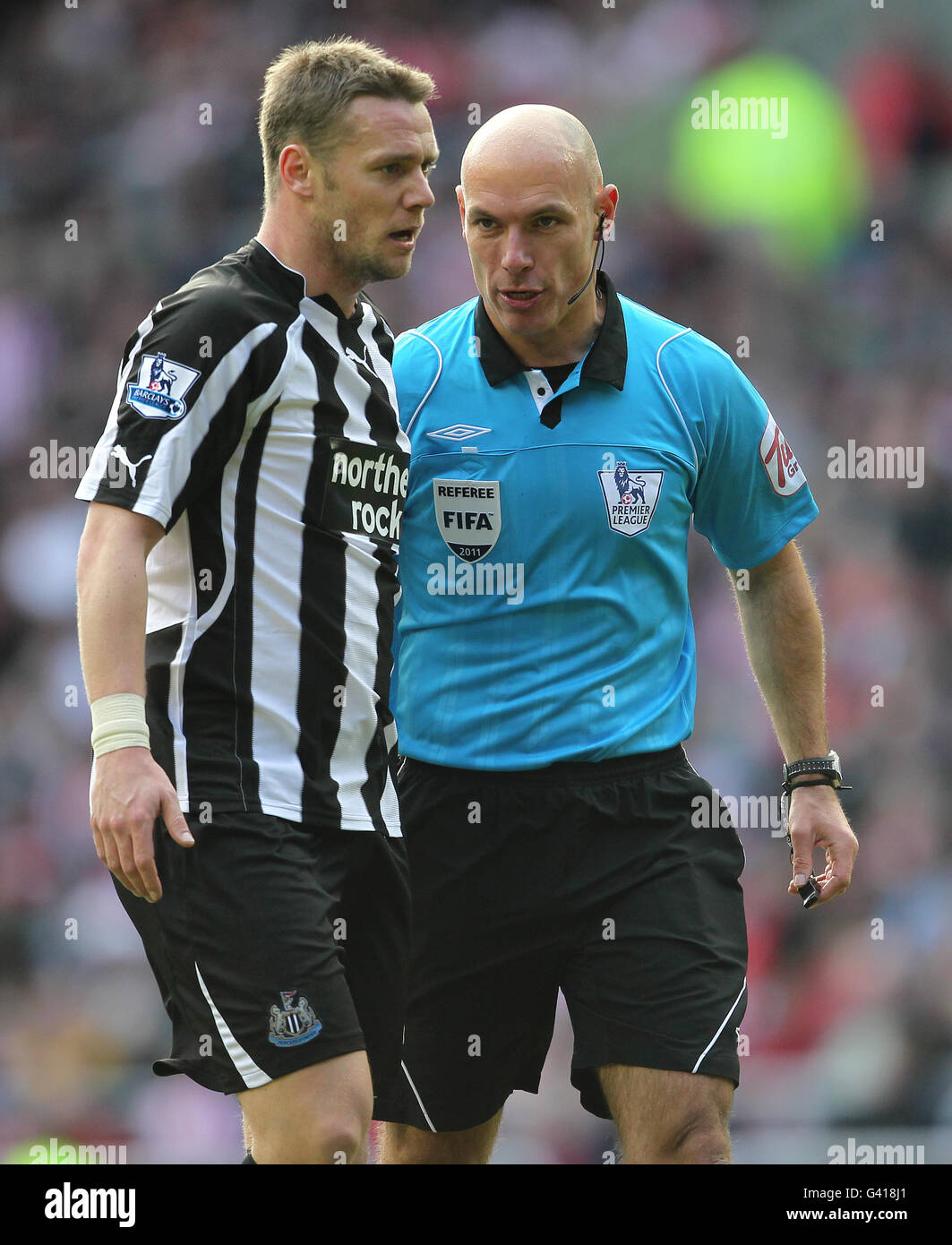 Referee Howard Webb (right) has a word with Newcastle United's Kevin ...