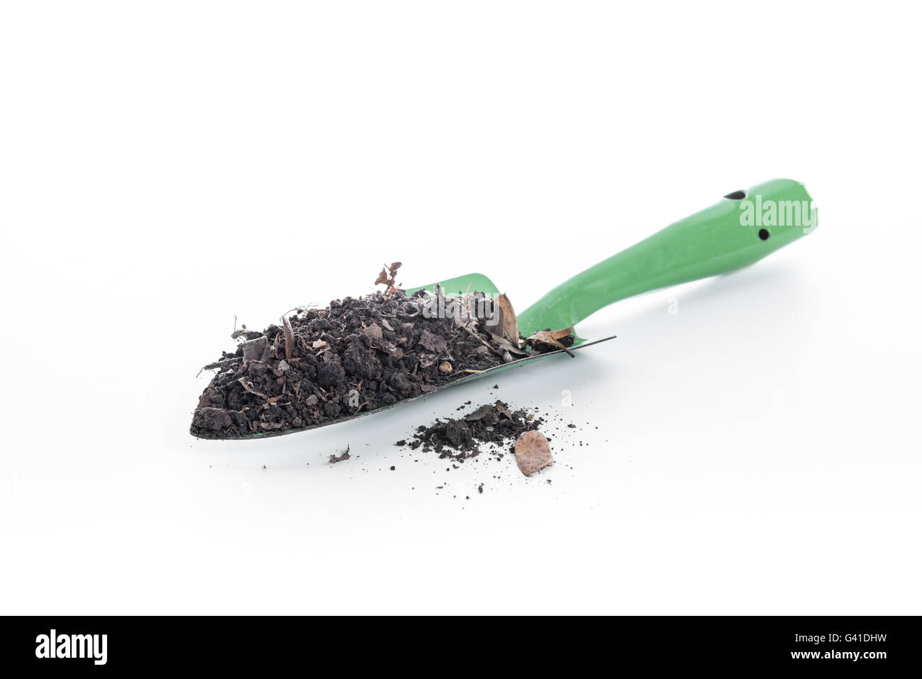 Green Garden trowel with soil on white background Stock Photo - Alamy