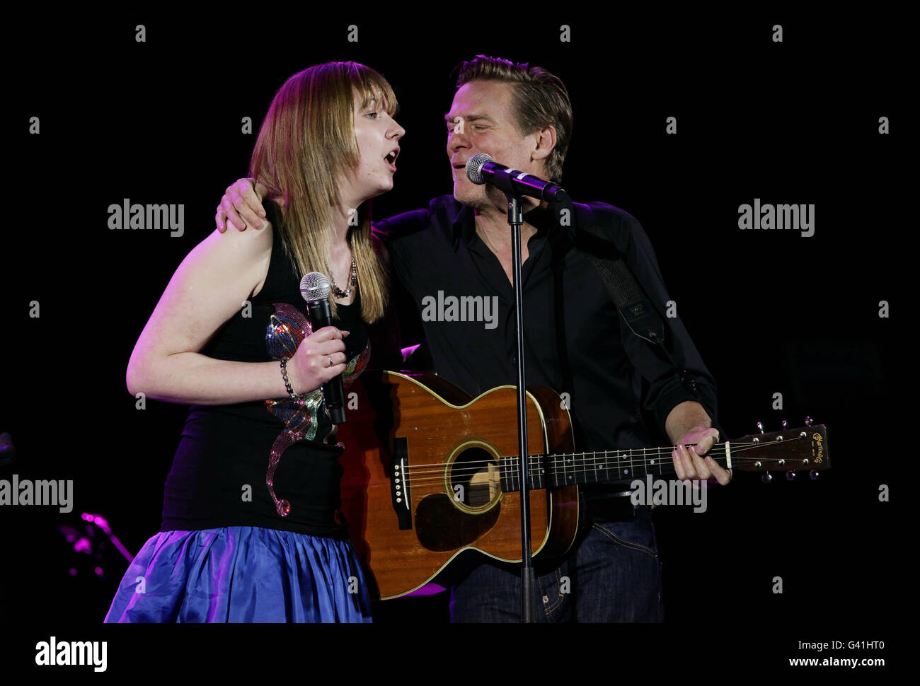 Bryan Adams performing with cancer survivor patient of the Killing ...