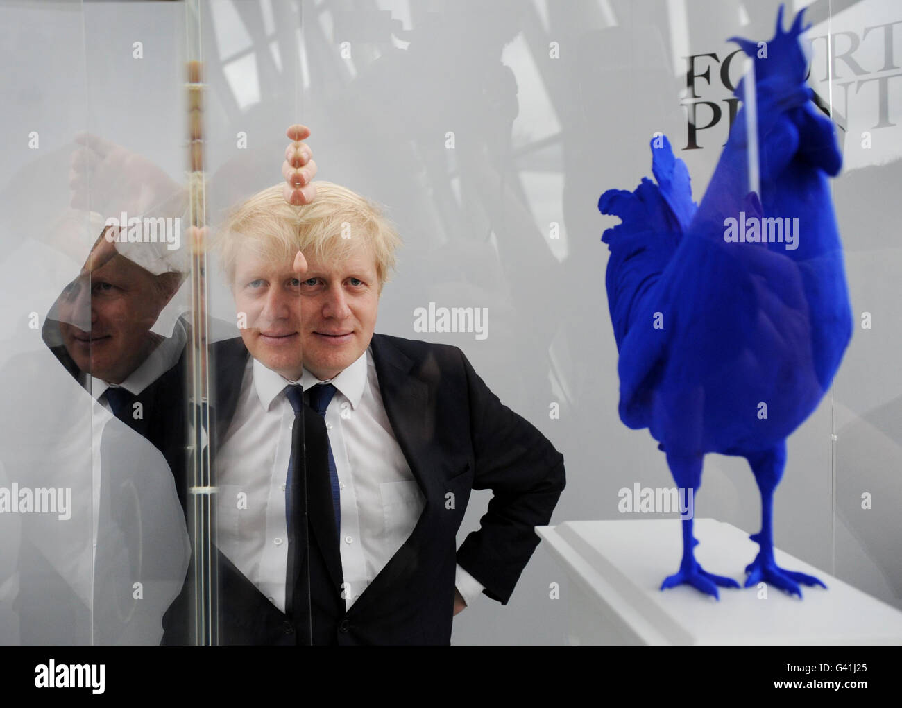 London Mayor Boris Johnson with a sculpture of a blue cockerel as he ...
