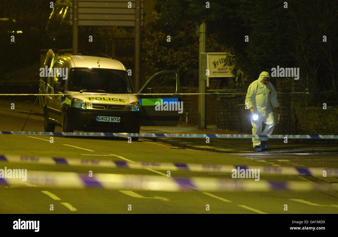 A police forensic officer investigates the scene in Dover, Kent, after ...