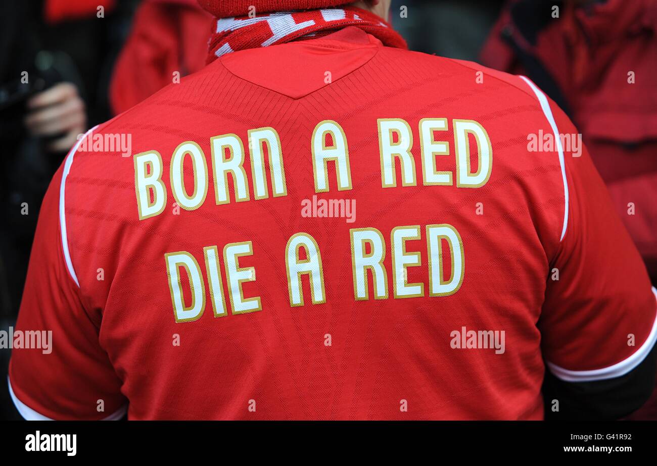 A fan wears a shirt with the words 'Born a red, die a red' Stock Photo ...