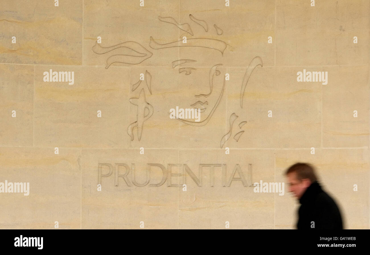 A man walks under the logo of financial services company Prudential, at ...