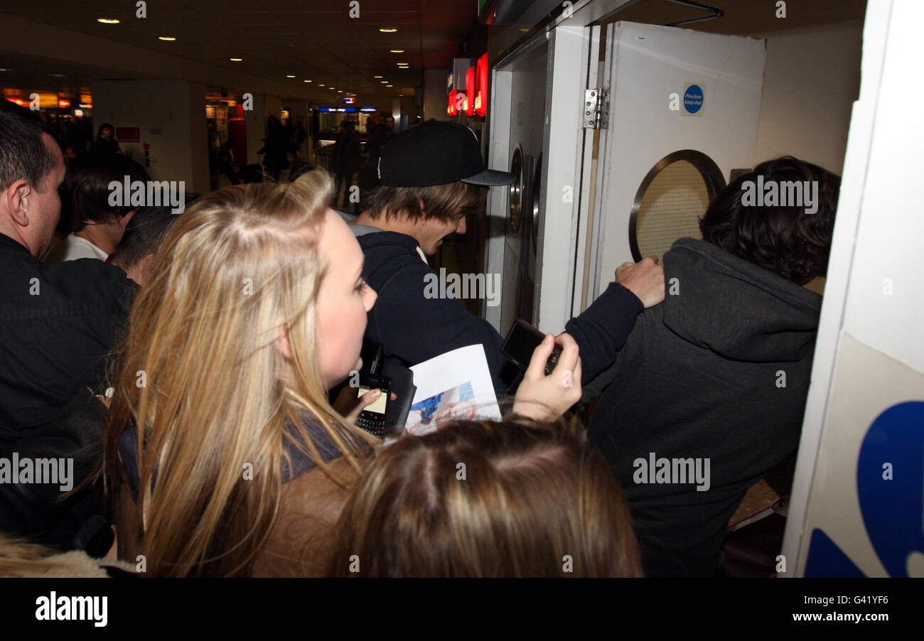 One Direction at Heathrow. Fans pursue X Factor boy band stars One ...