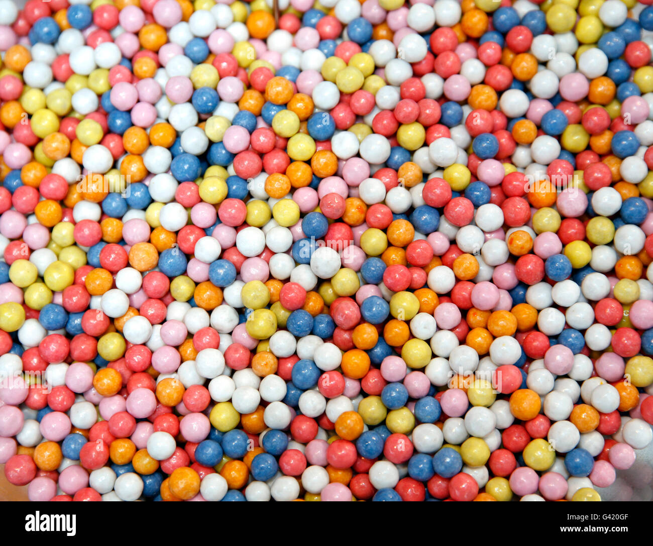 Heap of sugared colorful sweet dragees as a background Stock Photo - Alamy