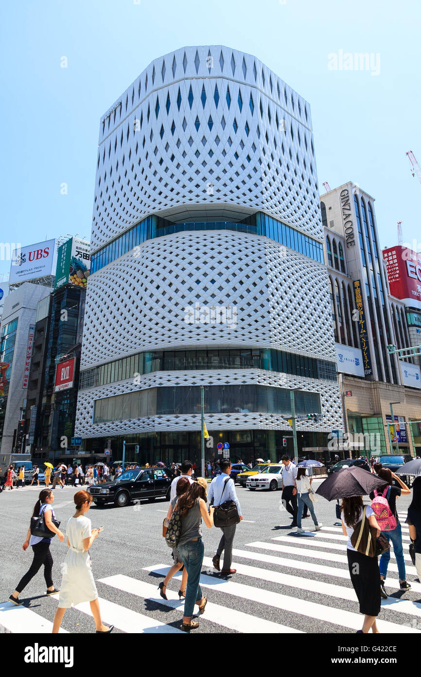Pedestrians walk past the Ginza Place under construction in Ginza ...