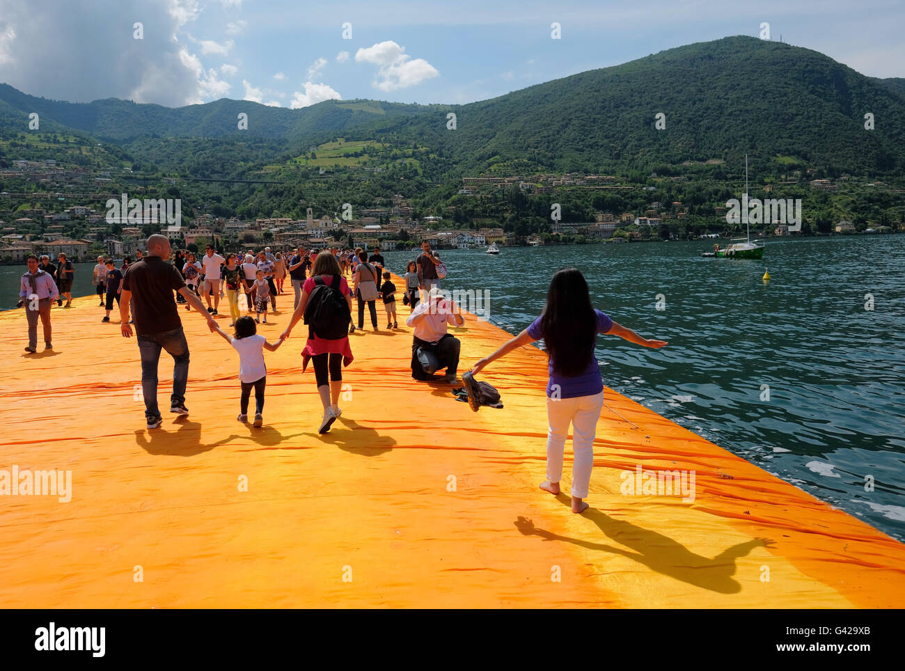 Paratico, Italy. 18th June, 2016. Visitors walk across floating piers ...