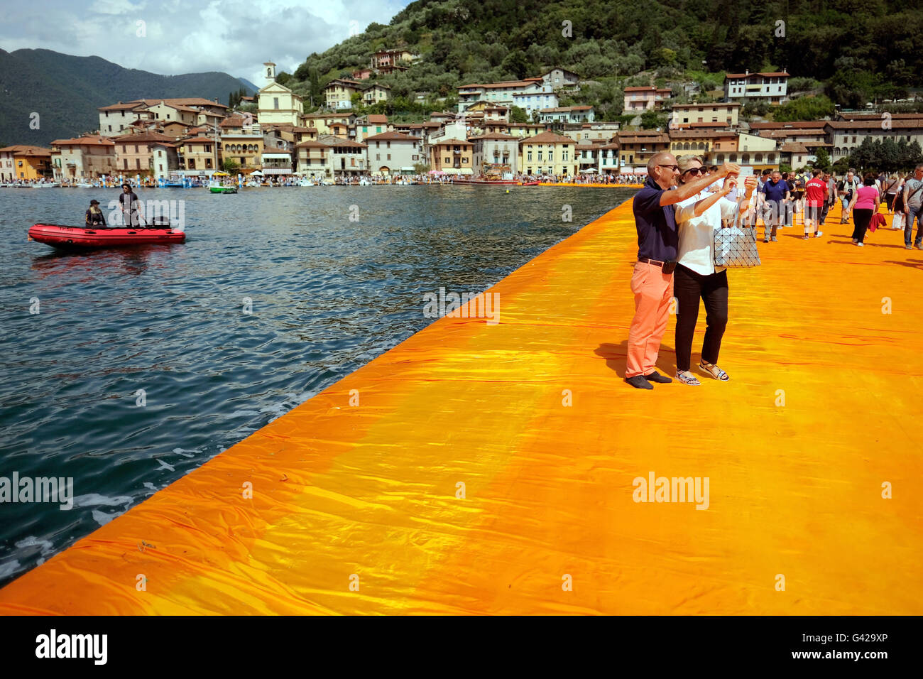 Paratico, Italy. 18th June, 2016. Visitors walk across floating piers ...