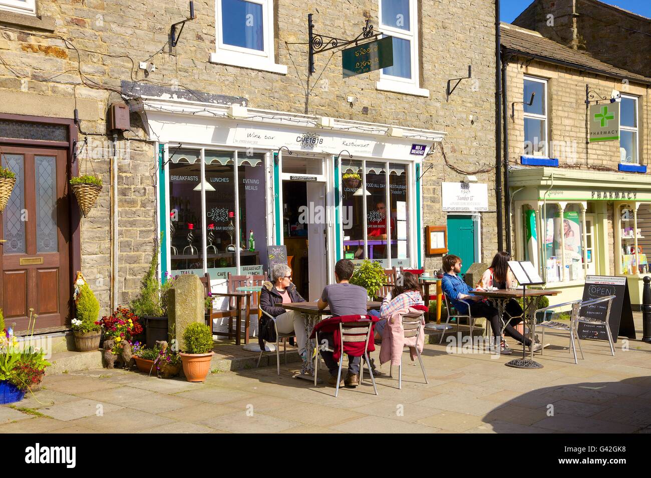 People sitting outside Cafe. Cafe1618,16 Market Place, Middleton-in ...