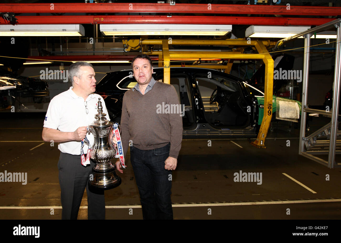 Former Everton player Graeme Sharp (right) poses with an employee of ...