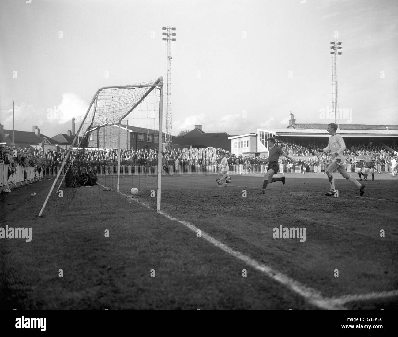 Percy Ames, the Colchester United goalkeeper, crashes to the ground in ...
