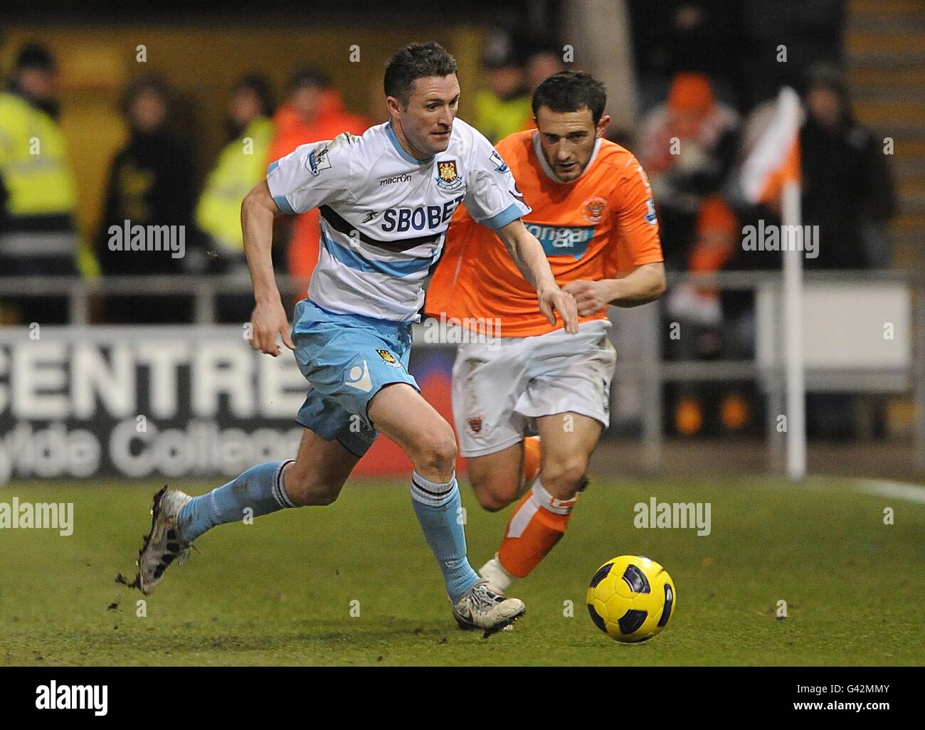 West Ham United's Robbie Keane and Blackpool's Neal Eardley (right) in ...