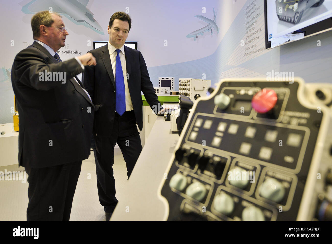 Chancellor George Osborne (right) looks at military hardware with ...