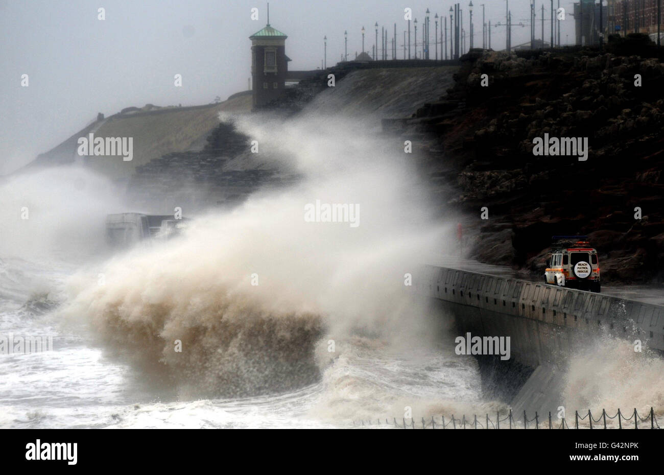 Waves crash over the promenade in Blackpool today as severe gales and ...
