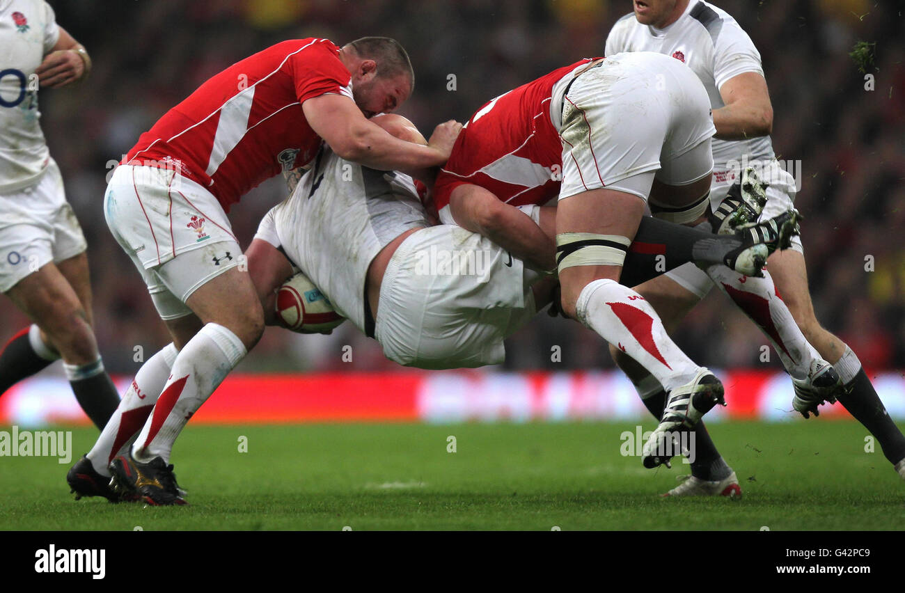 England's Dylan Hartley is tackled by Wales' Craig Mitchell and Alun ...