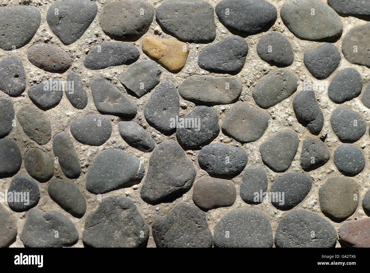 pebbled stone floor in front of Greek house Stock Photo - Alamy