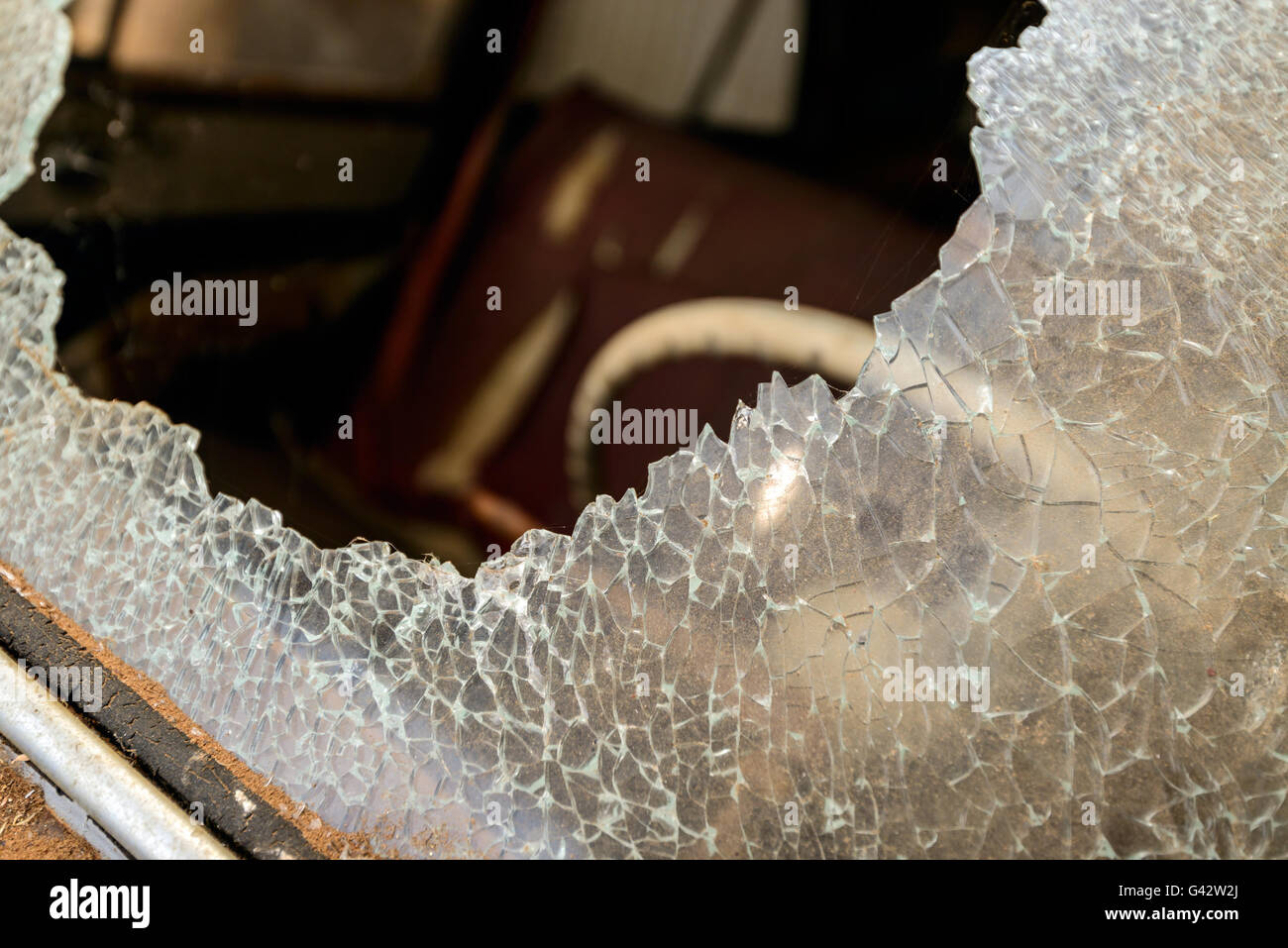 Cracked car windshield with hole in the middle Stock Photo - Alamy