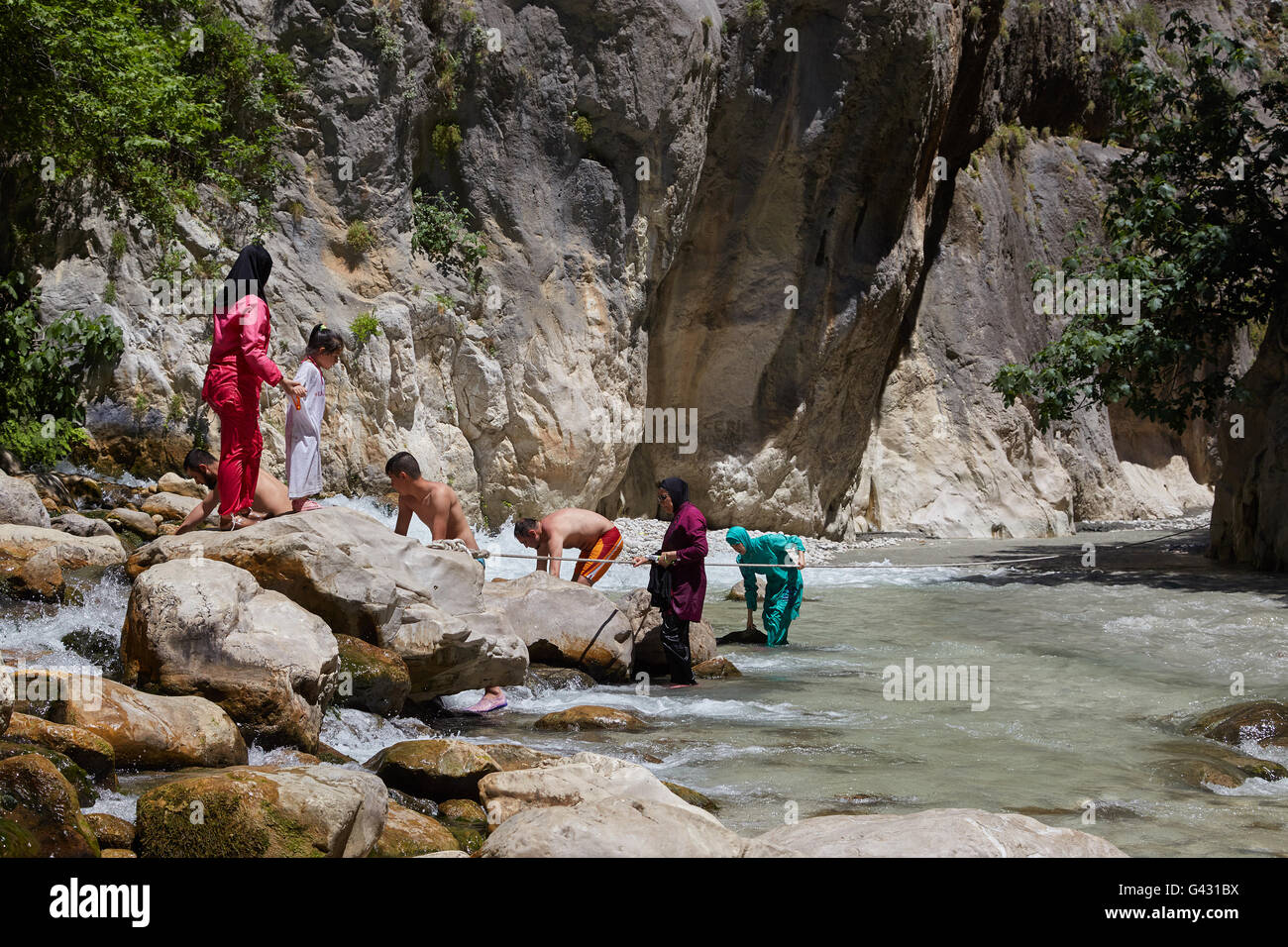 Tourists using a rope to cross the river in Saklikent Gorge, Turkey ...