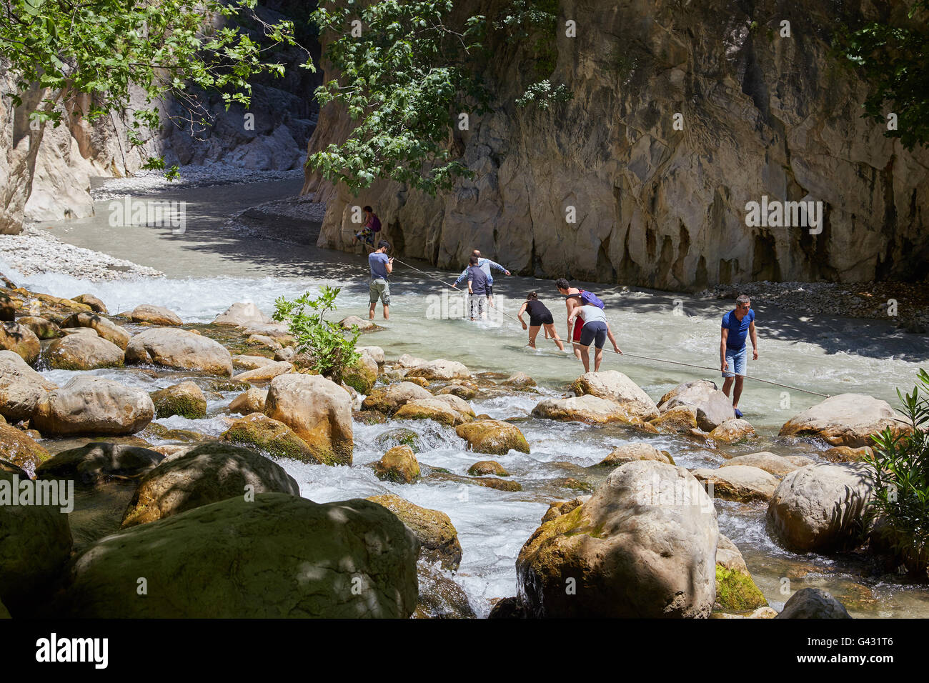 Tourists using a rope to cross the river in Saklikent Gorge, Turkey ...