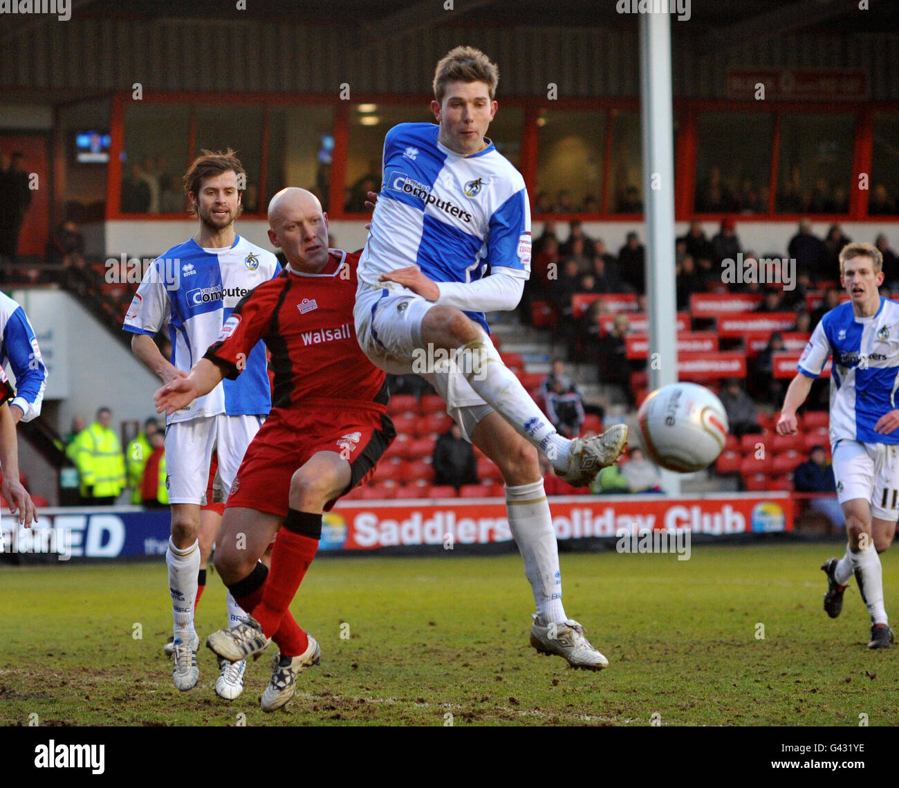 Bristol Rovers' Dominic Blizzard (right) clears from Walsall's Matt ...