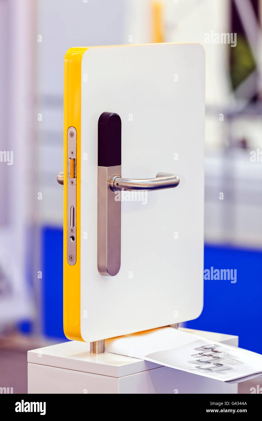 Metal door handle mechanism on exhibition wall Stock Photo - Alamy