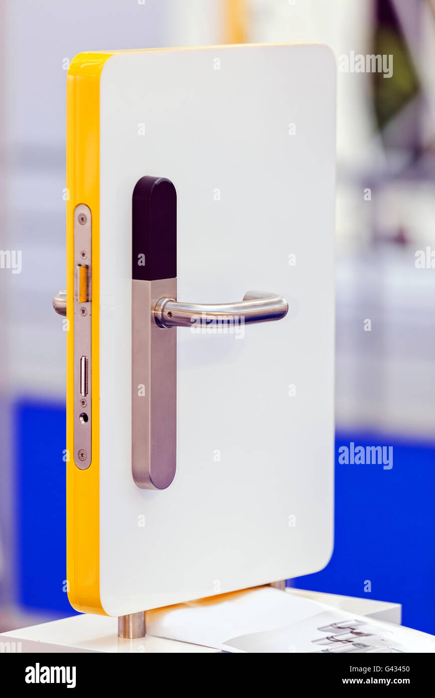 Metal door handle mechanism on exhibition wall Stock Photo - Alamy