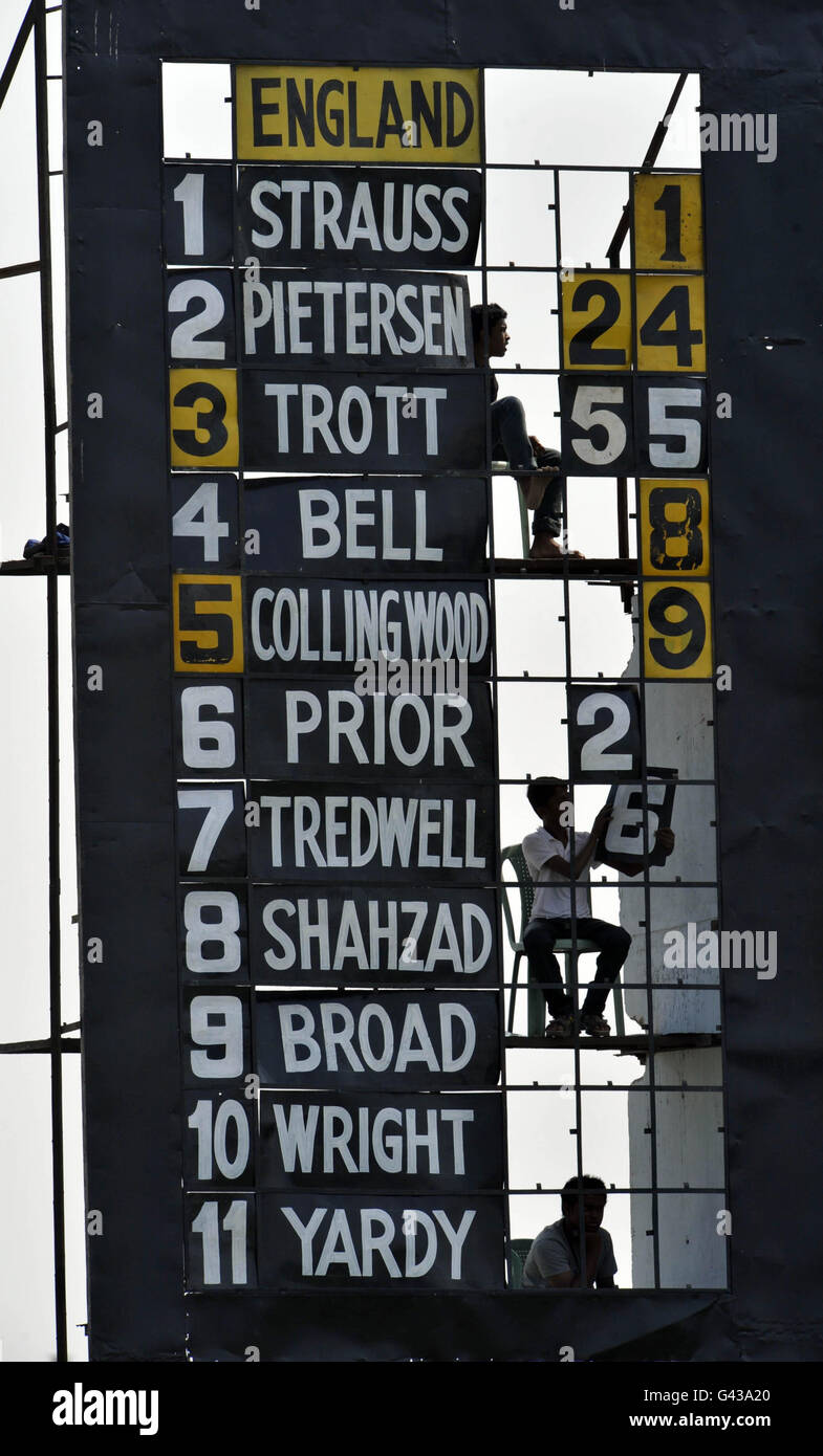 Members of staff alter the scoreboard during the warm up match at the ...