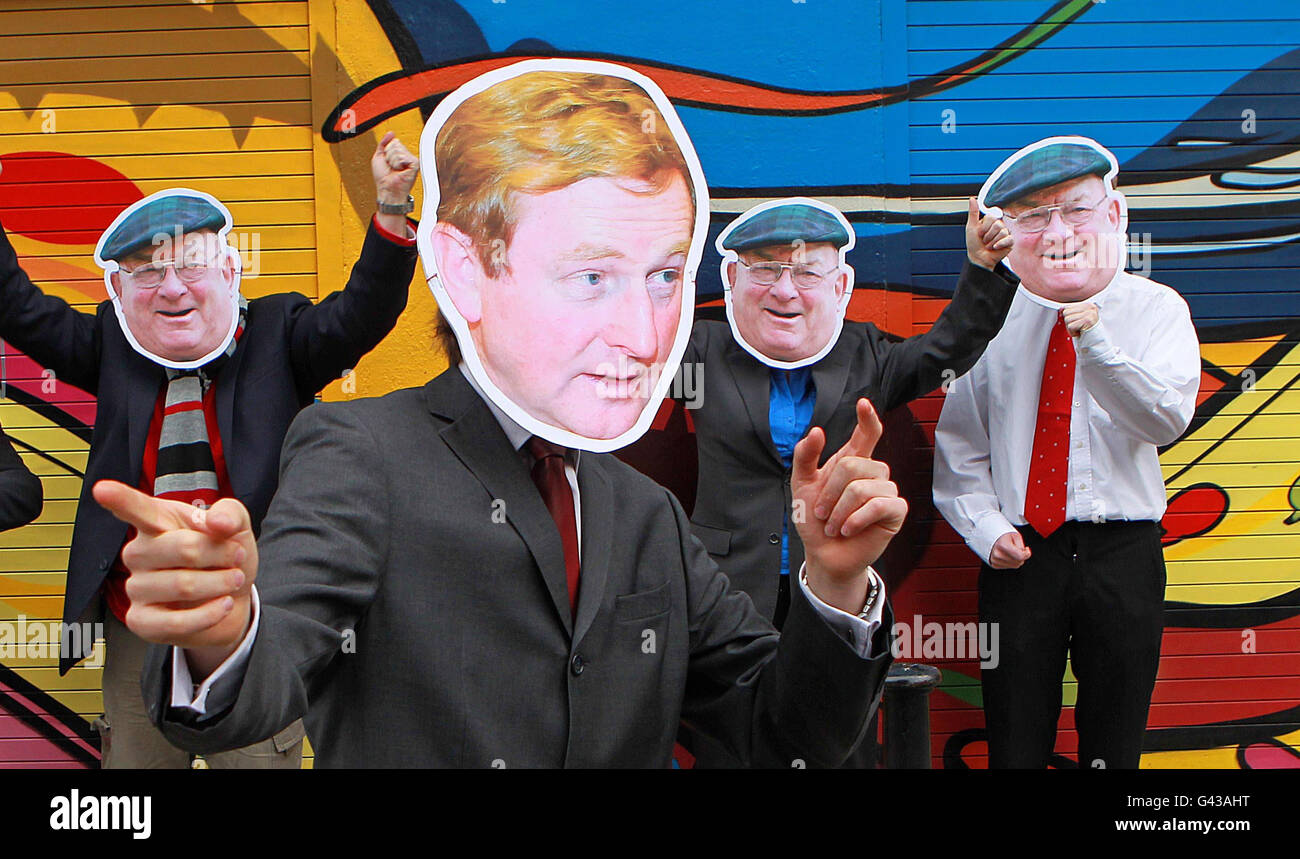 Green Party members wearing masks of Fine Gael leader Enda Kenny and ...