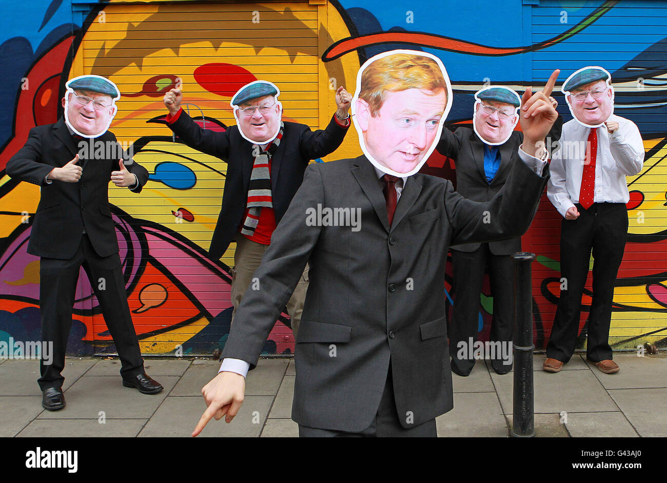 Green Party members wearing masks of Fine Gael leader Enda Kenny and ...