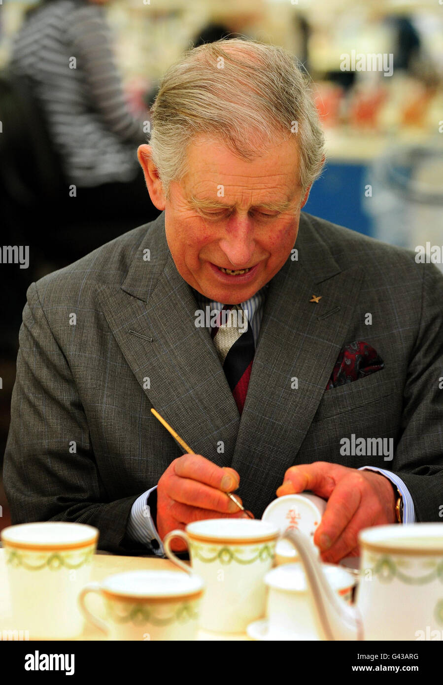 Prince Charles gilding a cup during a visit to Royal Crown Derby in ...