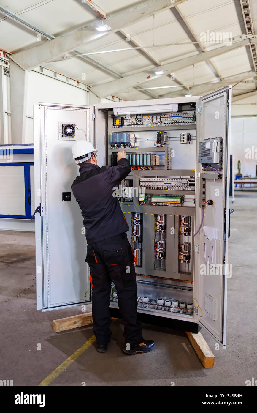 Man worker checking advanced industrial control panel in the production ...