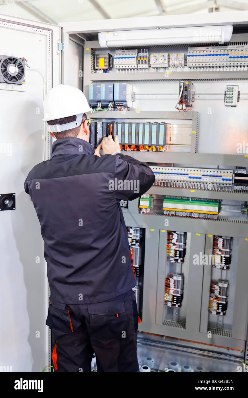 Man worker checking advanced industrial control panel Stock Photo - Alamy