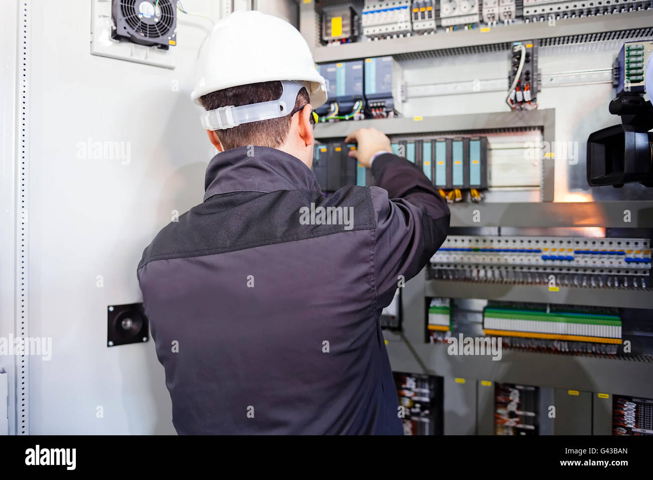 Closeup man worker checking advanced industrial control panel; note ...