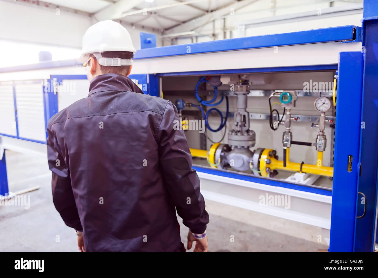 Closeup man worker checking advanced industrial control panel; note ...
