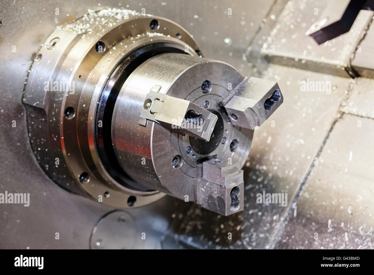 Industrial lathe tool and part of the lathe machine; note shallow depth ...