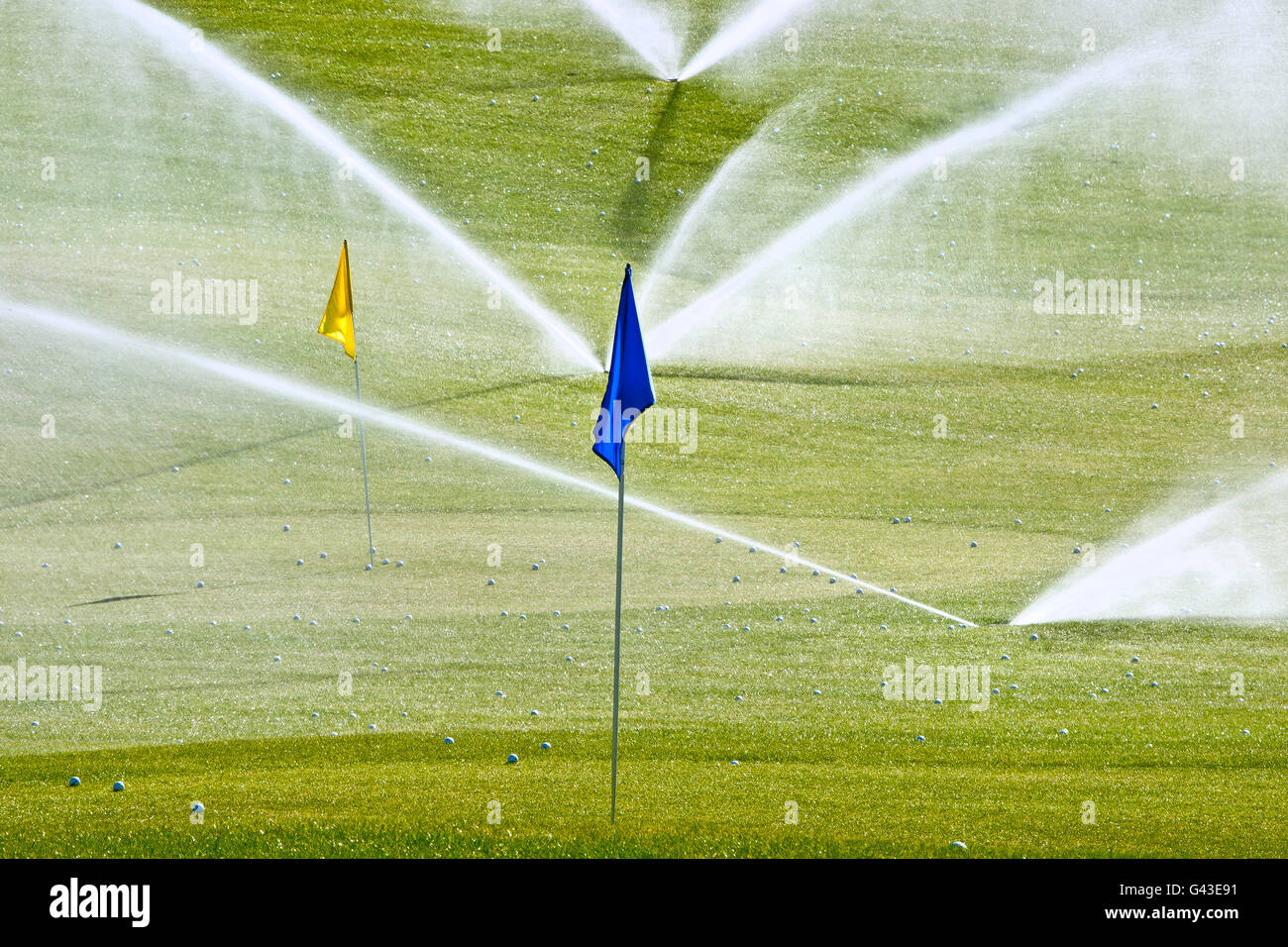 Water waste on golf driving range Stock Photo - Alamy